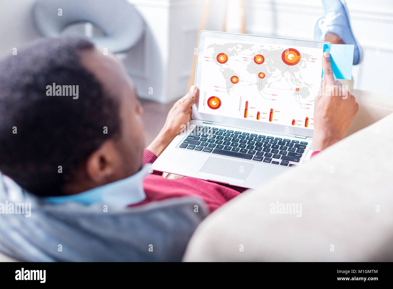 Handsome nice man looking at the statistics Stock Photo - Alamy