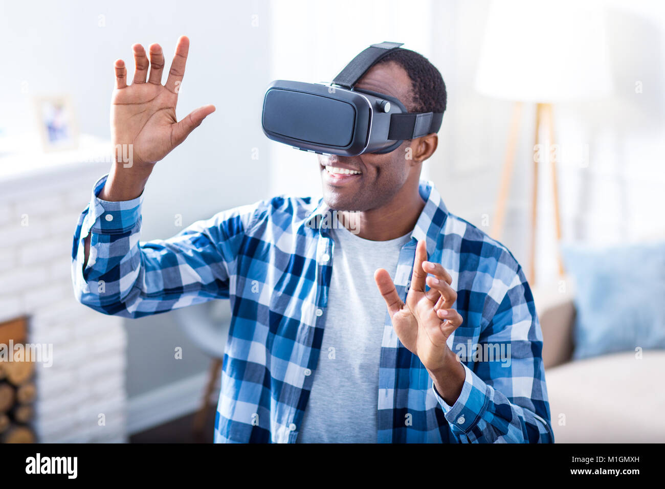Positive young man using virtual technology Stock Photo - Alamy