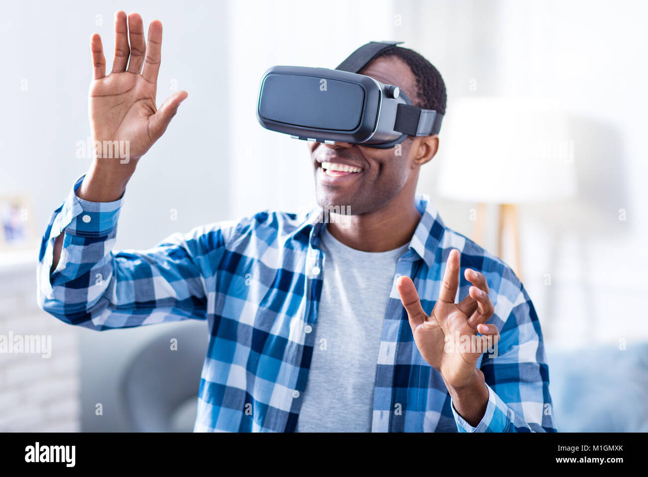Happy nice man experiencing virtual reality Stock Photo - Alamy