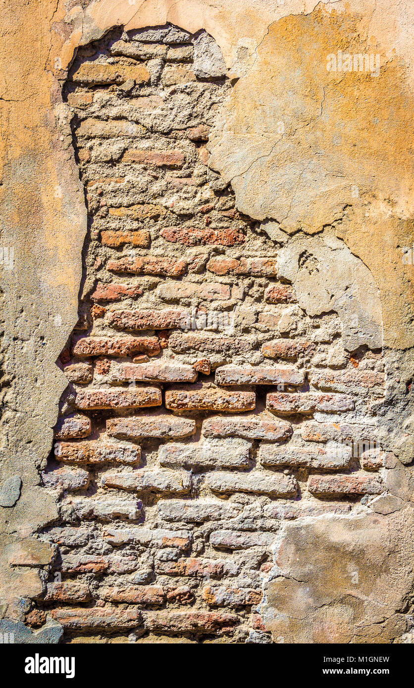 The plaster fell off the old brick wall Stock Photo - Alamy