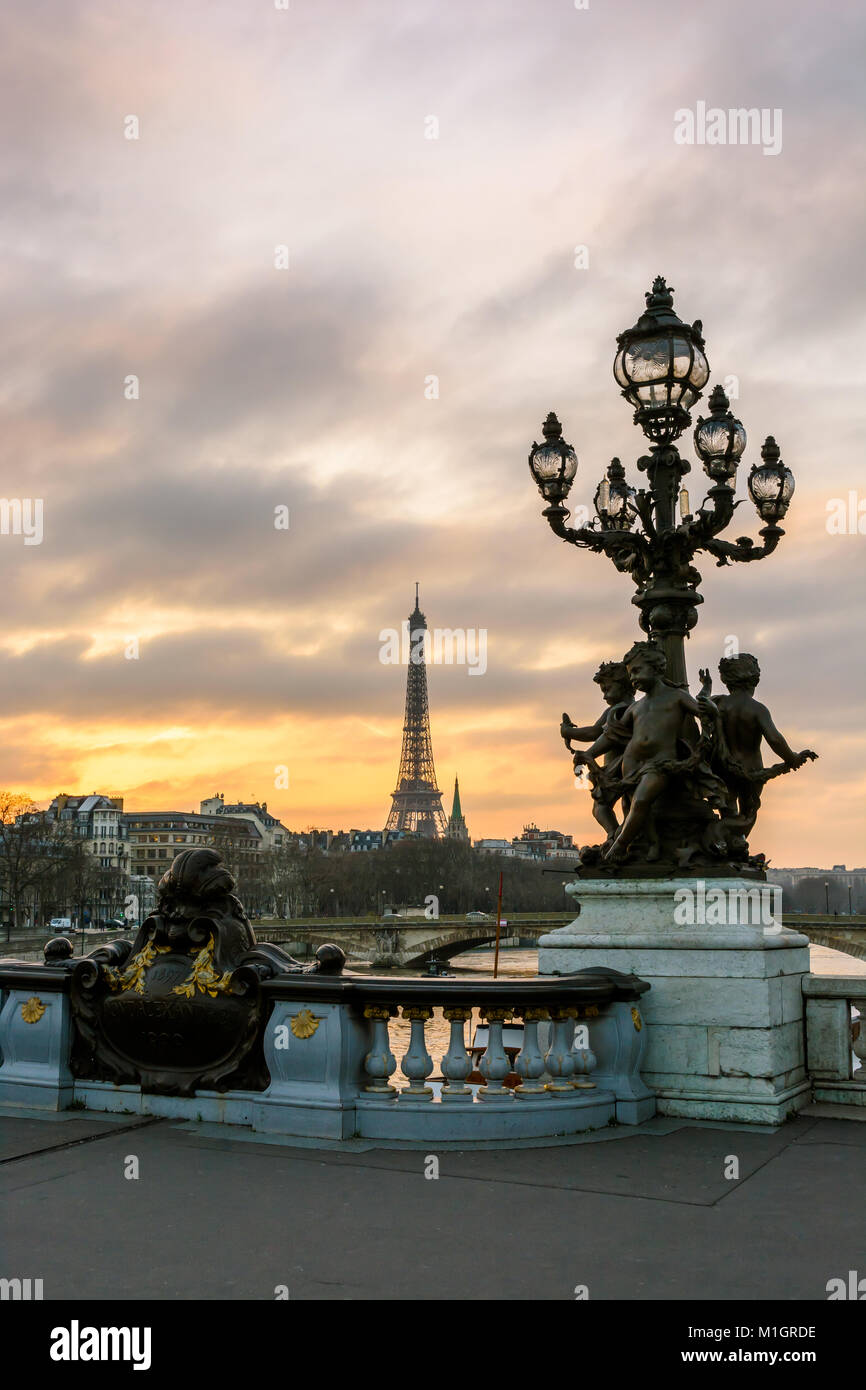 View of the Eiffel tower from the Pont Alexandre III at sunset with one ...