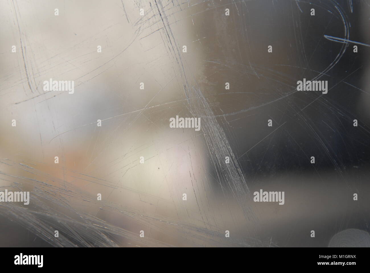 scratchings in a window with blurred background: grey colored Stock ...