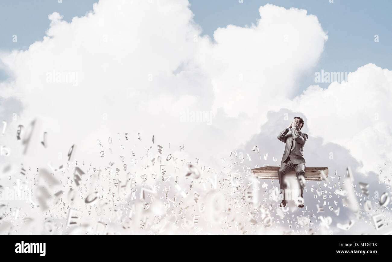 Young man floating in sky and do not want to see anything Stock Photo ...