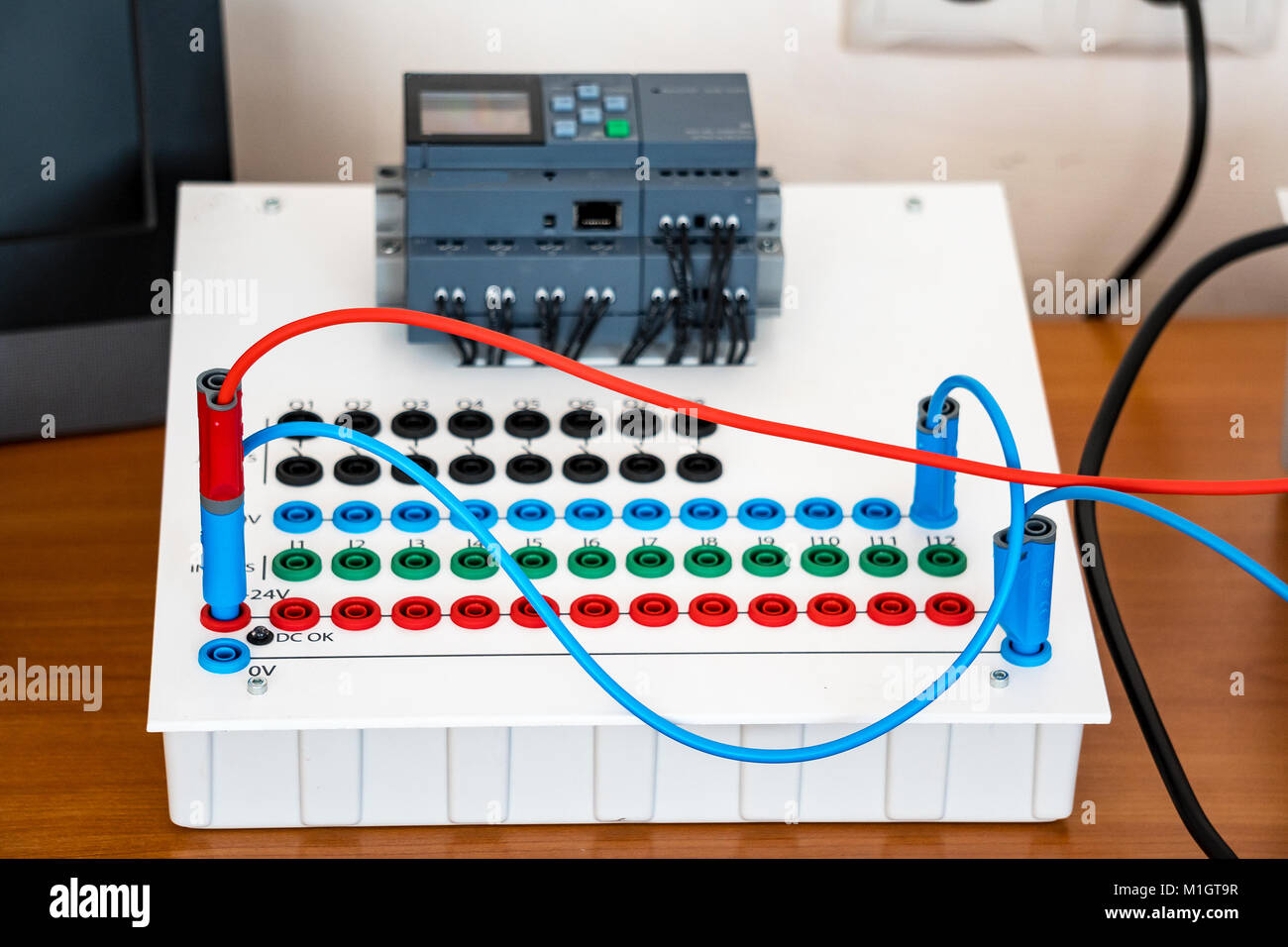Electric educational device white color with the wires on the table ...
