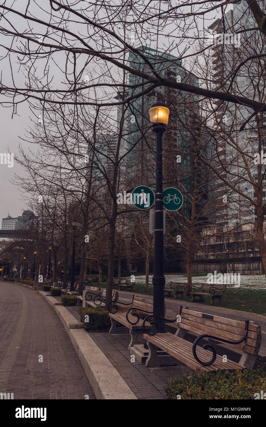 Empty park in downtown with benches and skyscrapers in Vancouver ...
