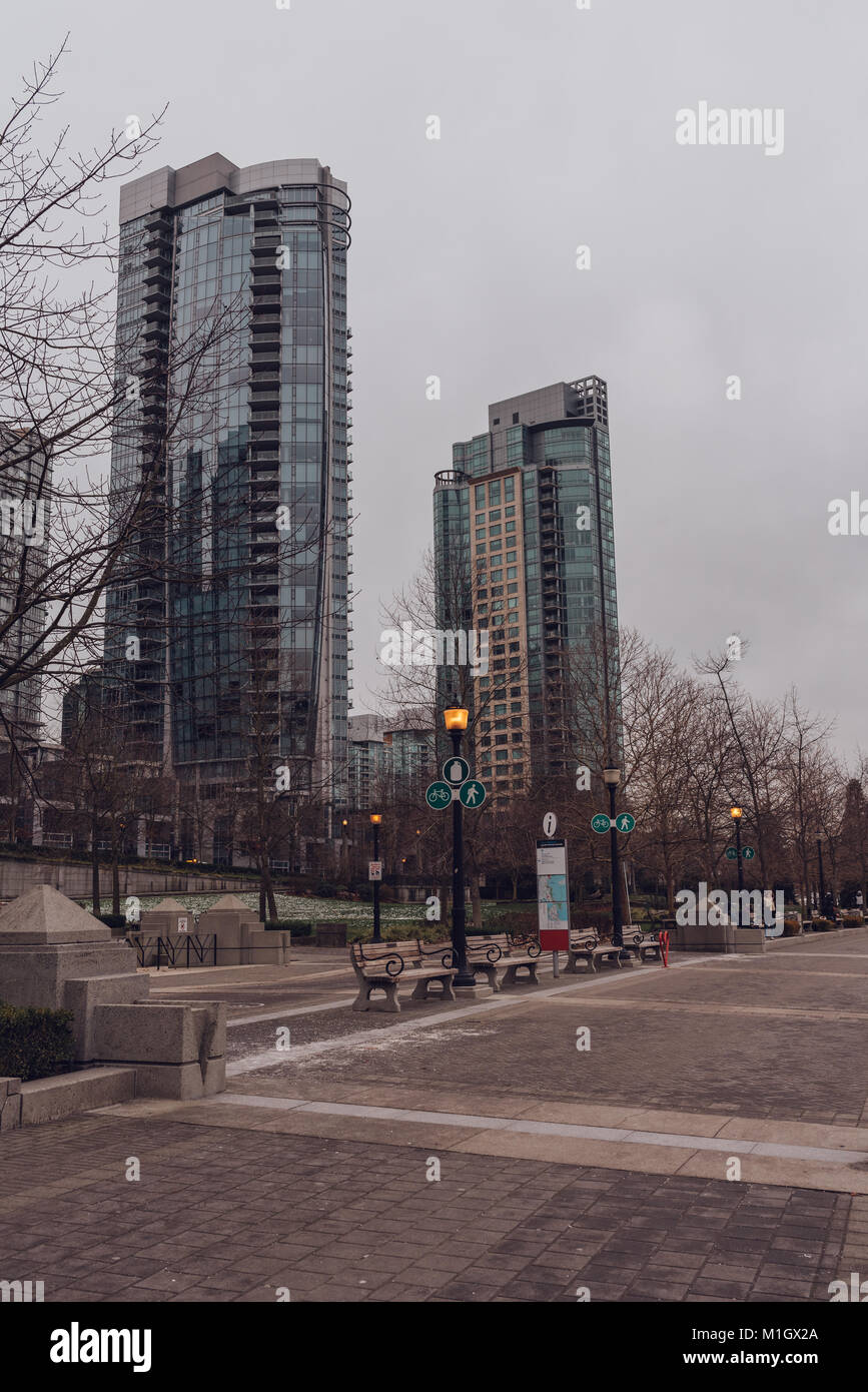 Empty park in downtown with benches and skyscrapers in Vancouver ...