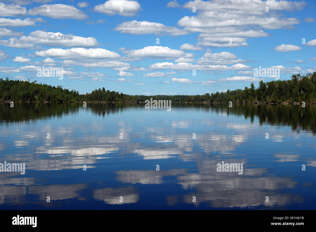 Reflections in Saganagons Lake in the Quetico in the summer Stock Photo ...