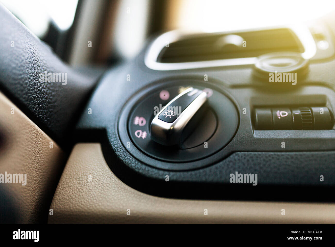 Lights control dial in a modern car Stock Photo - Alamy