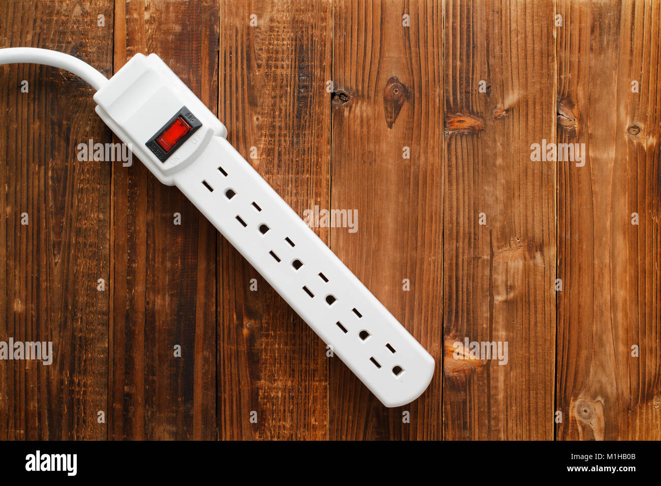 Electrical power strip on wood. Top down view Stock Photo - Alamy
