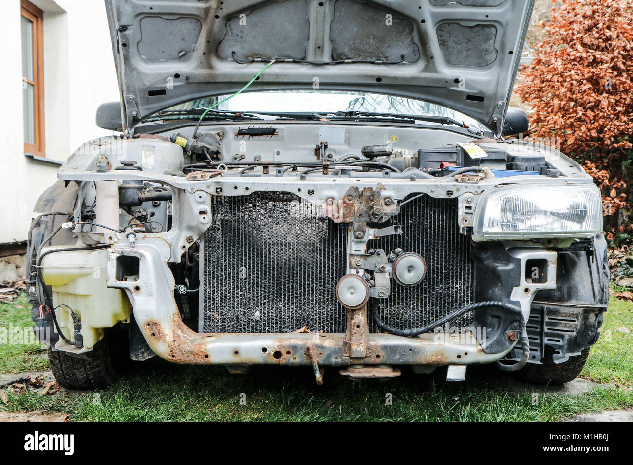 A detail of the old car wreck. The front of the car is visible, some ...