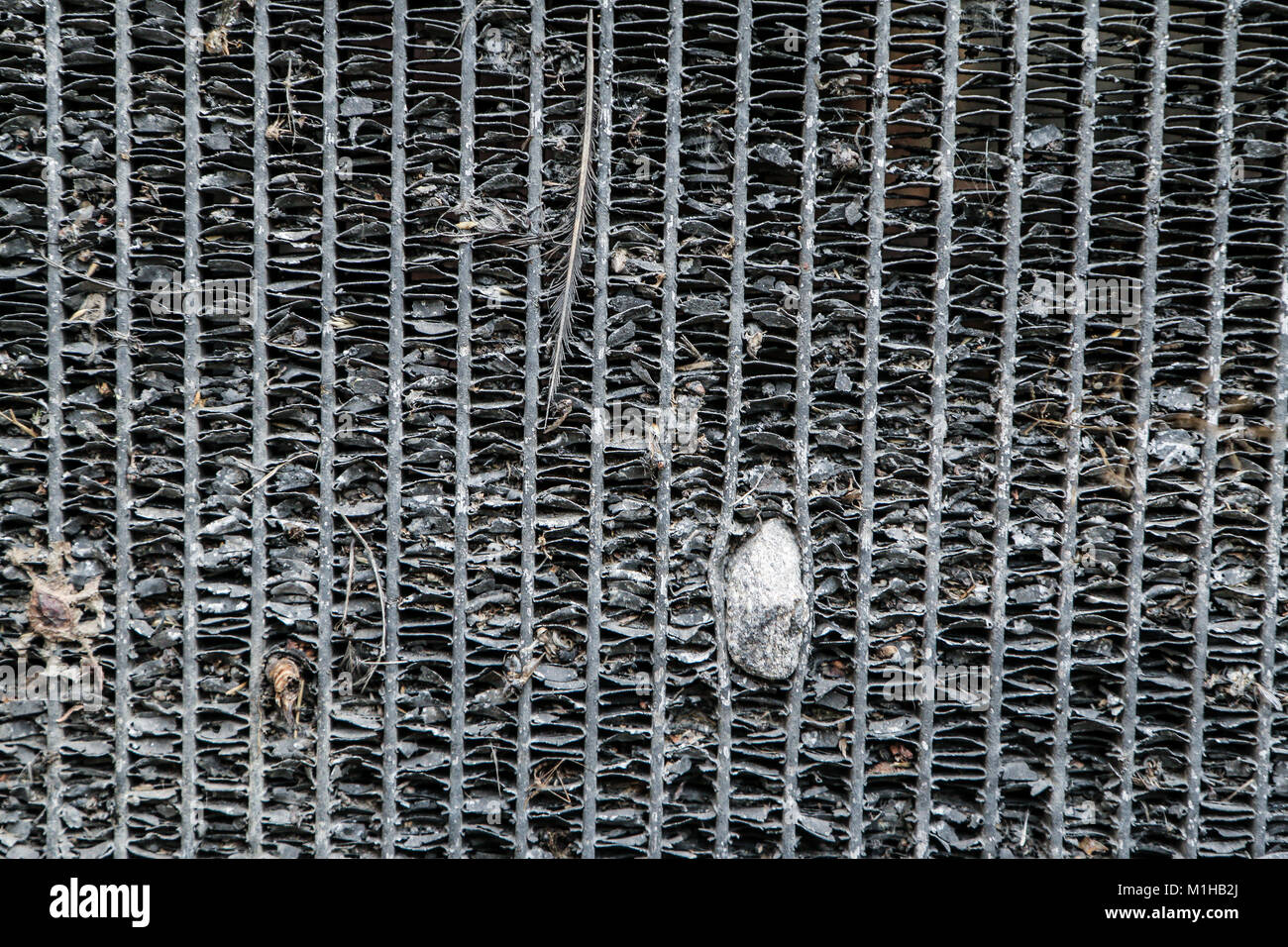 A detail of the old car wreck. The dirty radiator with a stone inside ...