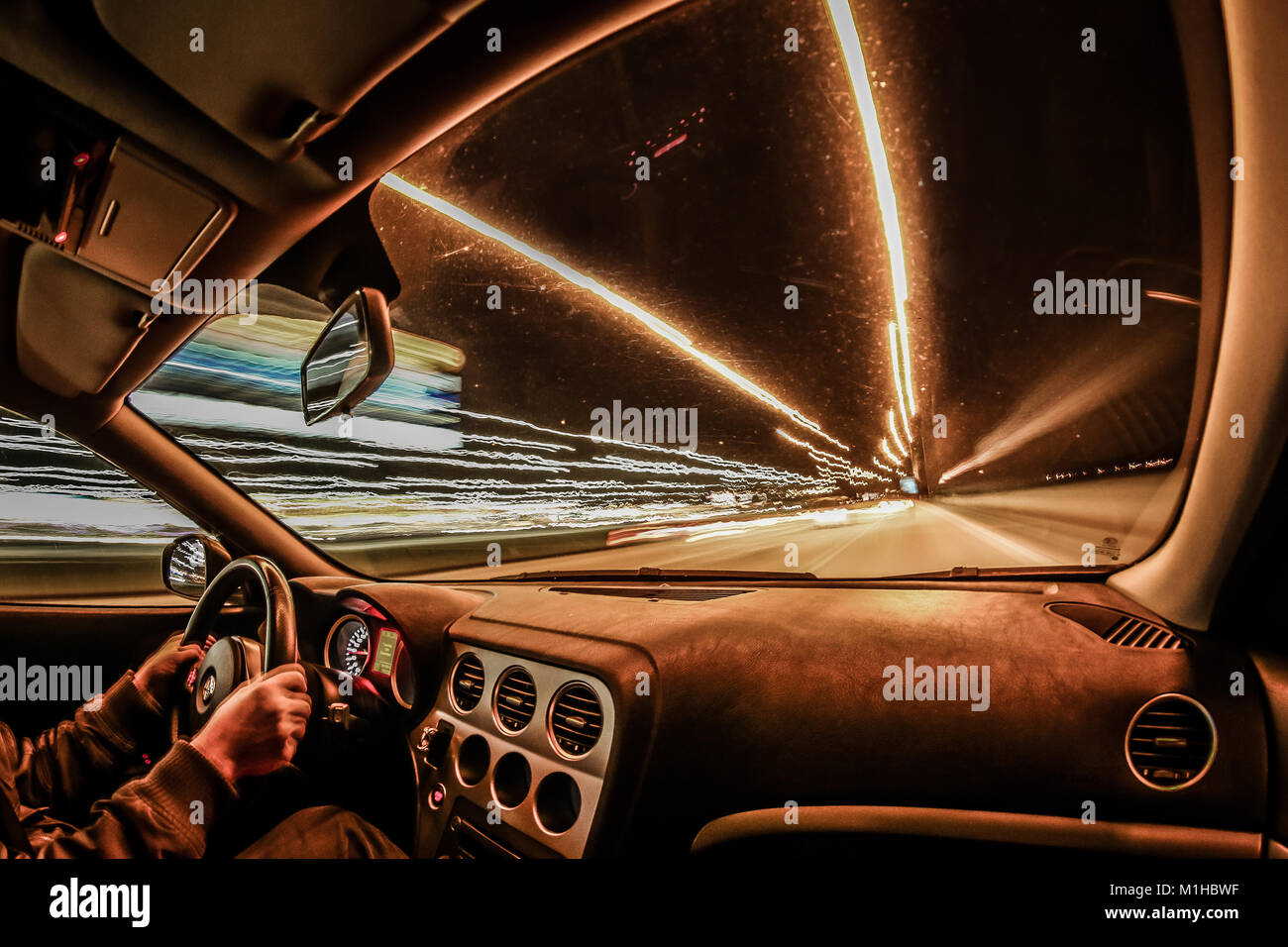 A picture from the interior of a car during the night drive through a ...