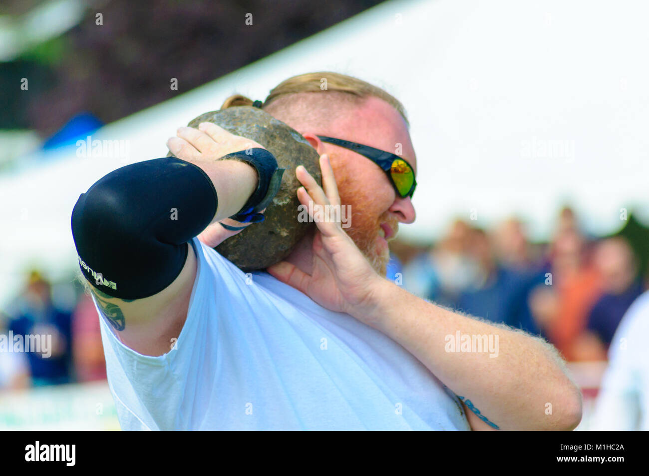 Muscular male prepares to throw in the stone put competition at the ...