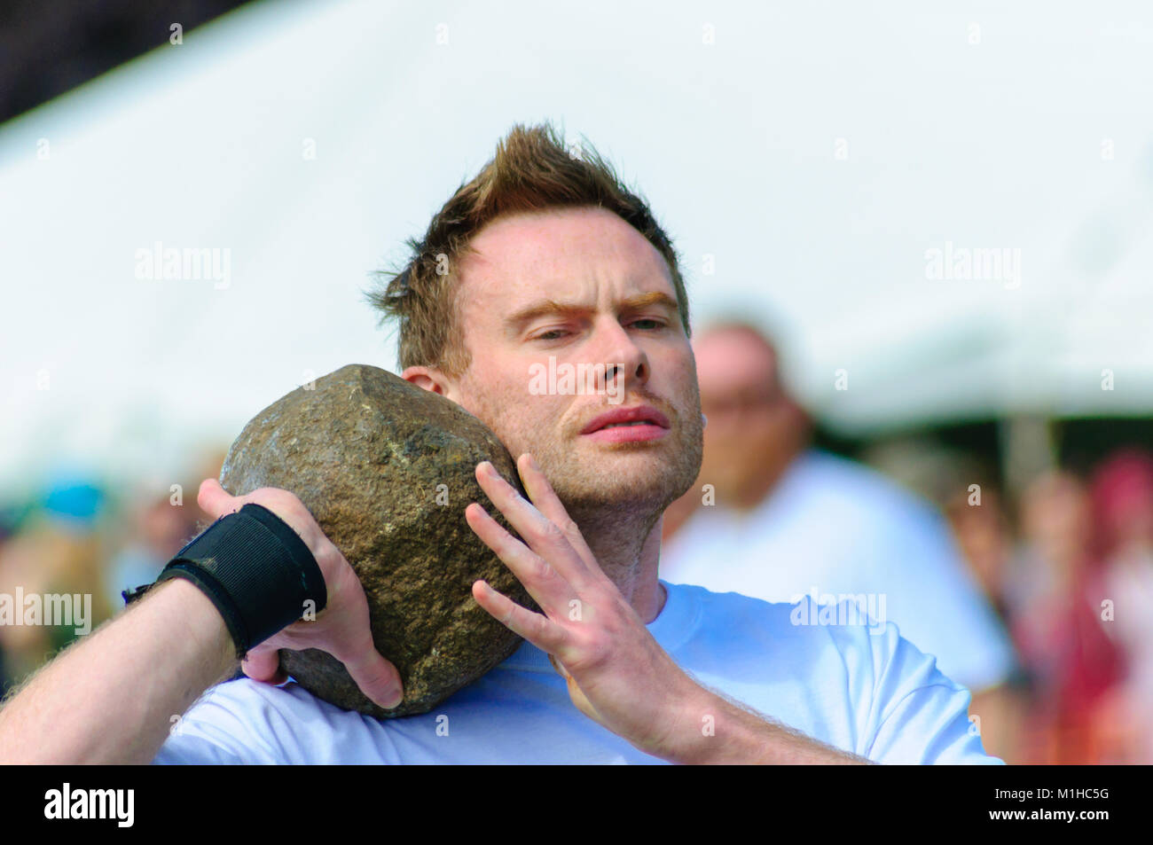 Muscular male prepares to throw in the stone put competition at the ...