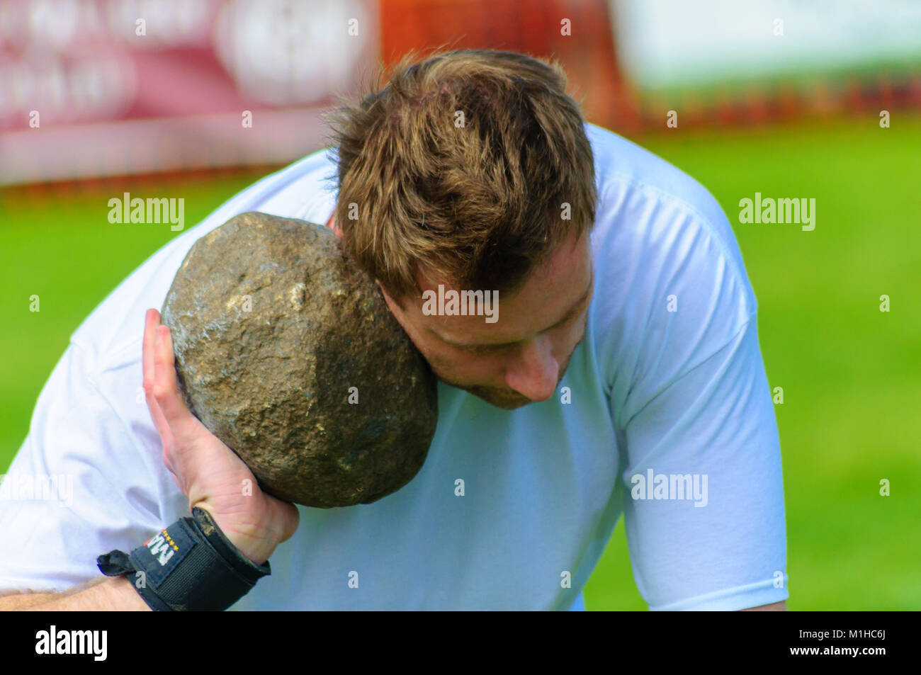 Muscular male prepares to throw in the stone put competition at the ...
