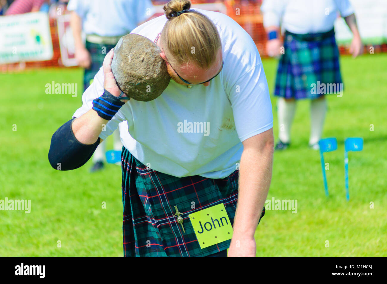 Muscular male prepares to throw in the stone put competition at the ...
