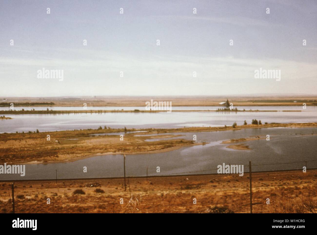 Photograph of a landscape consisting of a river with heaps of land and ...