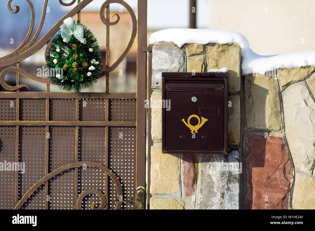 Metal post box fixed on the front gate Stock Photo - Alamy
