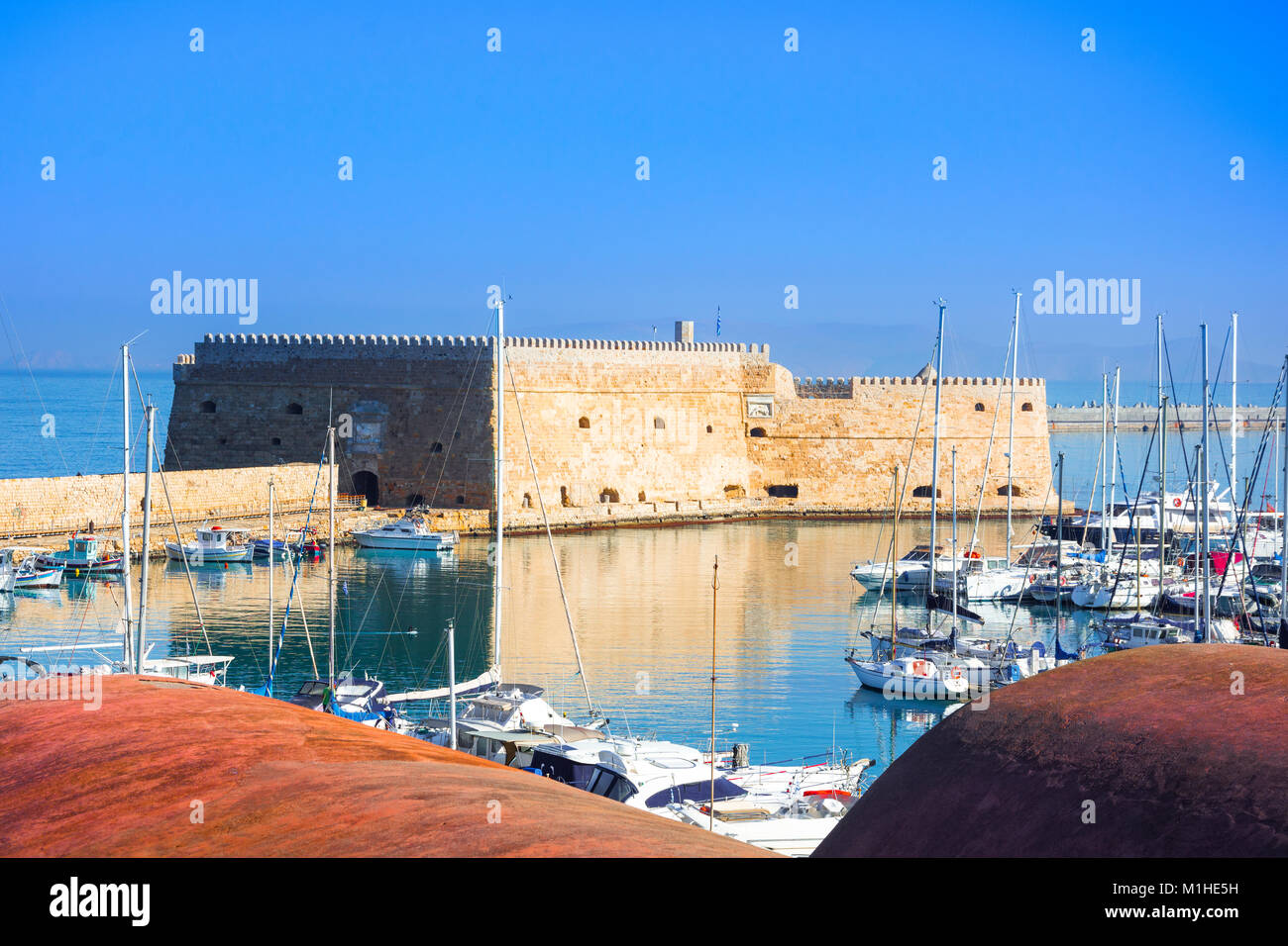 Heraklion harbour with old venetian fort Koule and shipyards, Crete ...