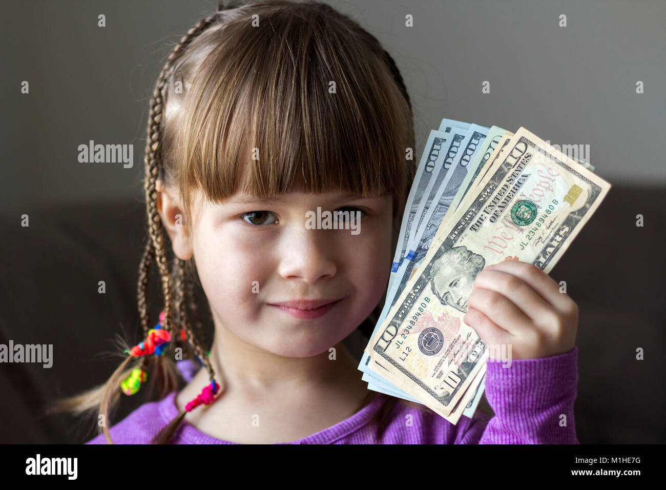 Money, finances and people concept - smiling little girl with dollar ...