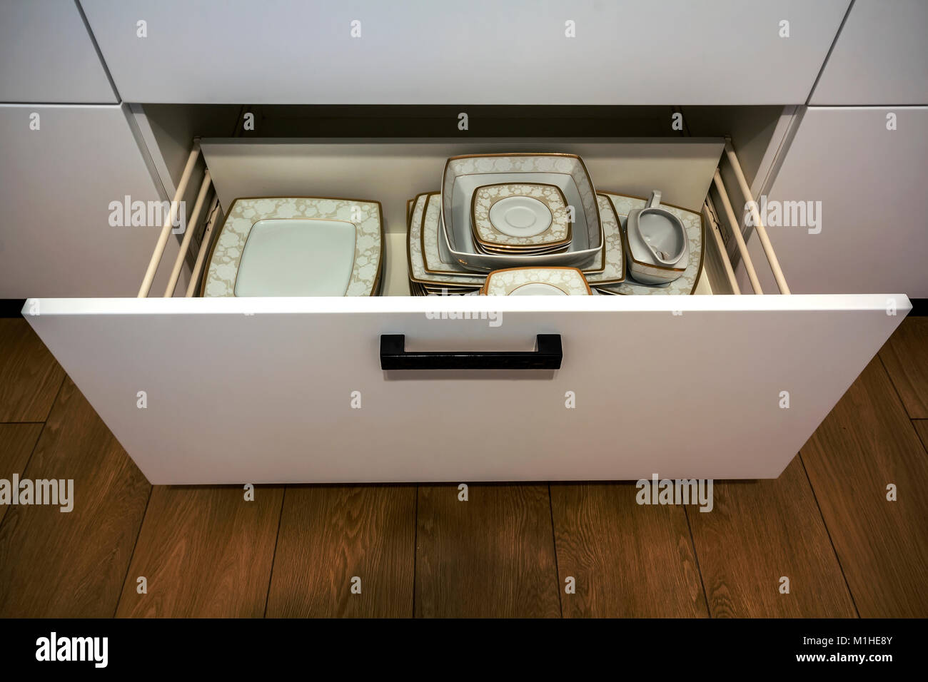 Open kitchen drawer with plates inside, a smart solution for kitchen ...