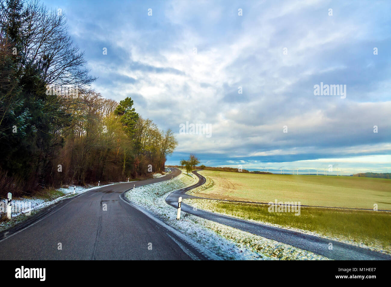 Empty black asphalt road between green fields Stock Photo - Alamy