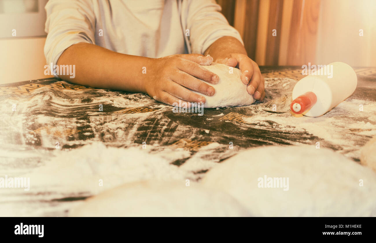 Girl making Pizza dough, preparing on kitchen table Stock Photo - Alamy