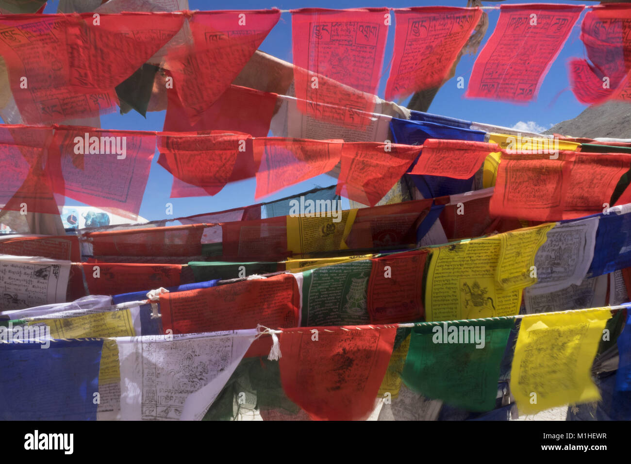 Buddhist prayer flags of different bright colors are fluttering in the ...