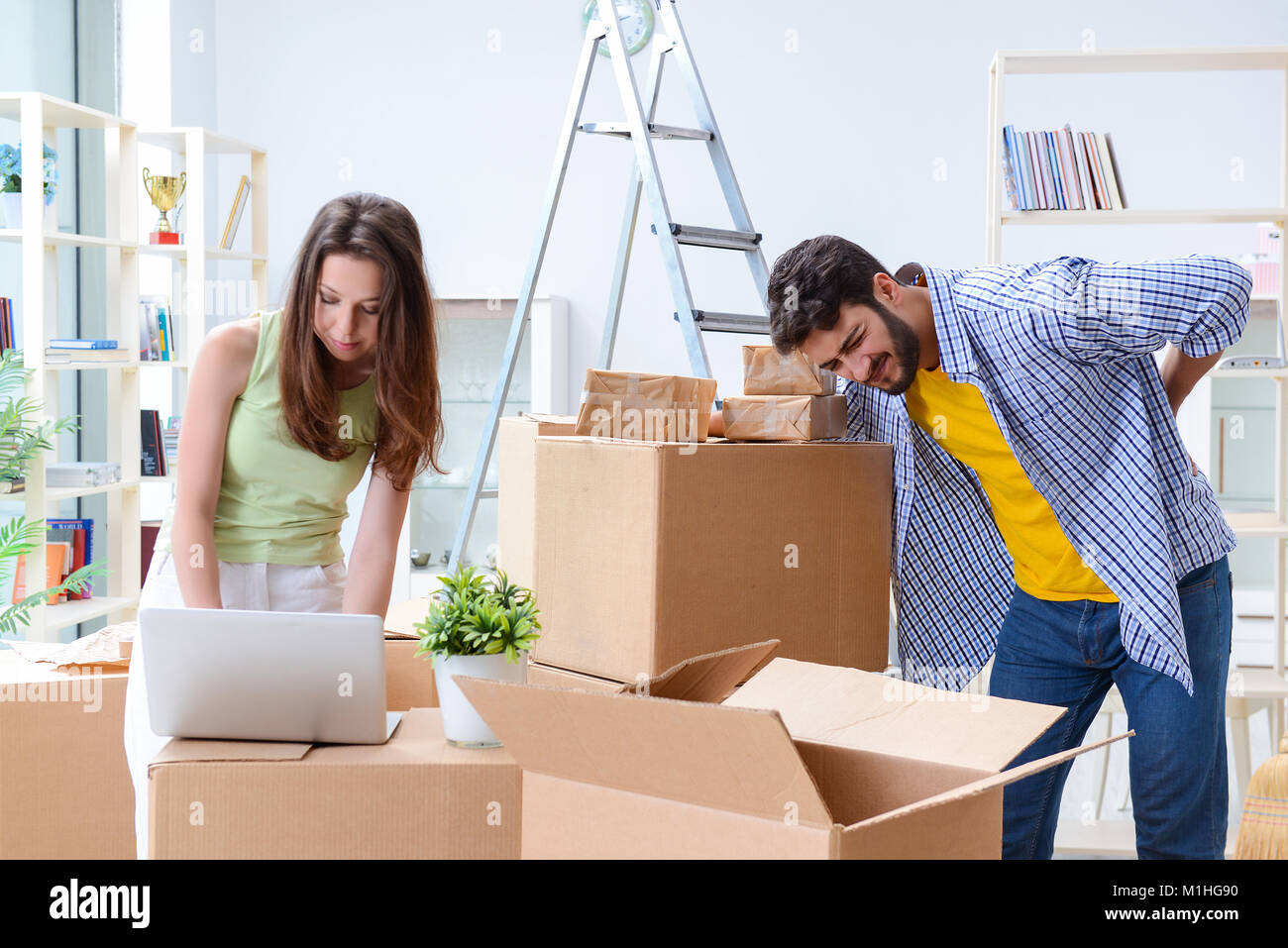 Young family unpacking at new house with boxes Stock Photo - Alamy