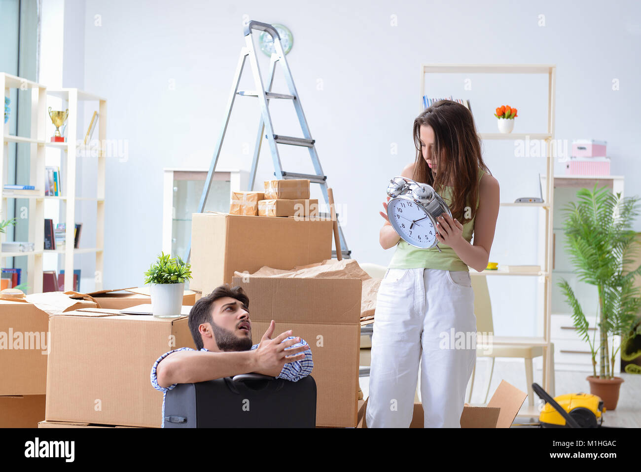 Young family unpacking at new house with boxes Stock Photo - Alamy