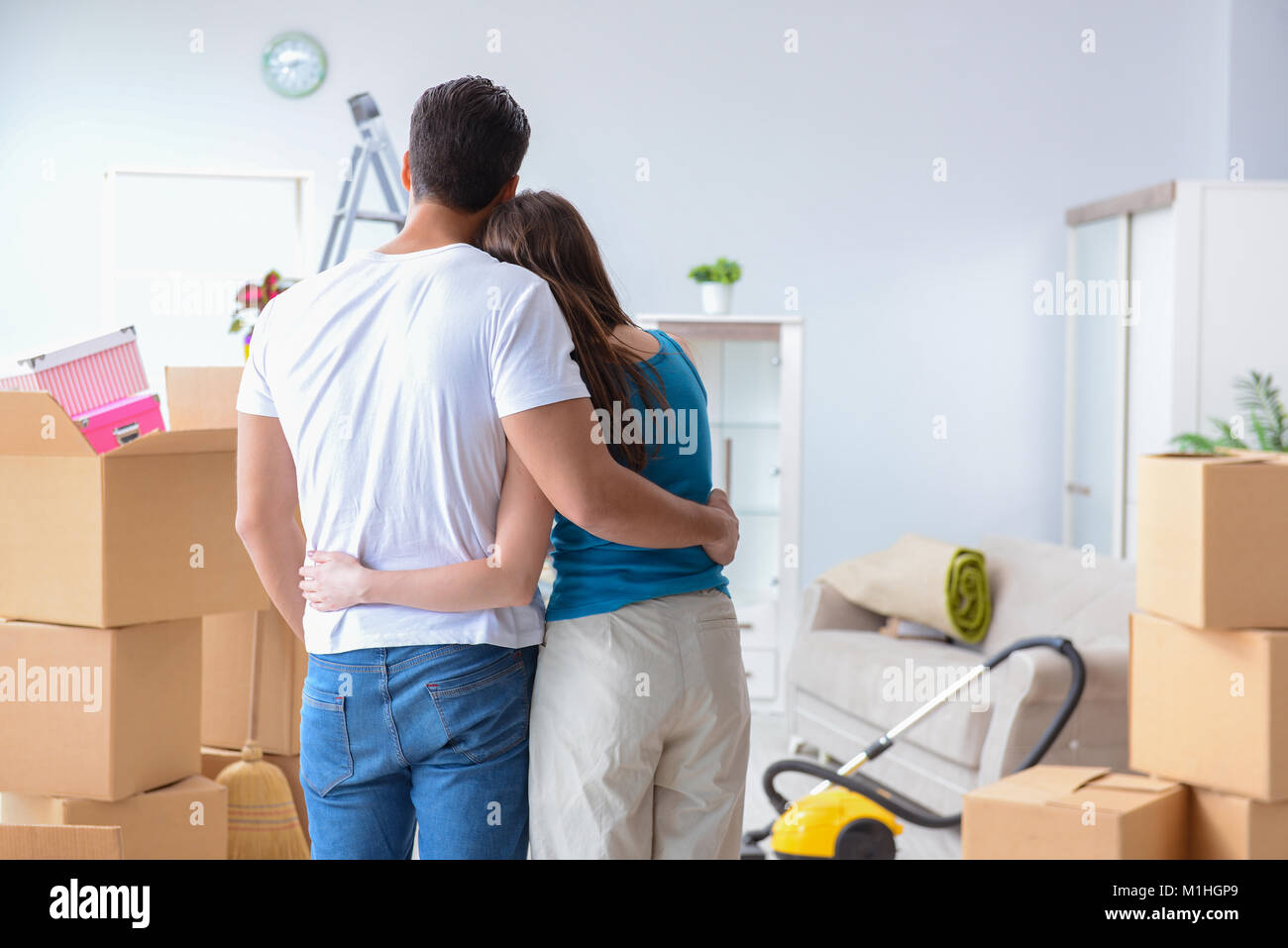 Young family unpacking at new house with boxes Stock Photo - Alamy