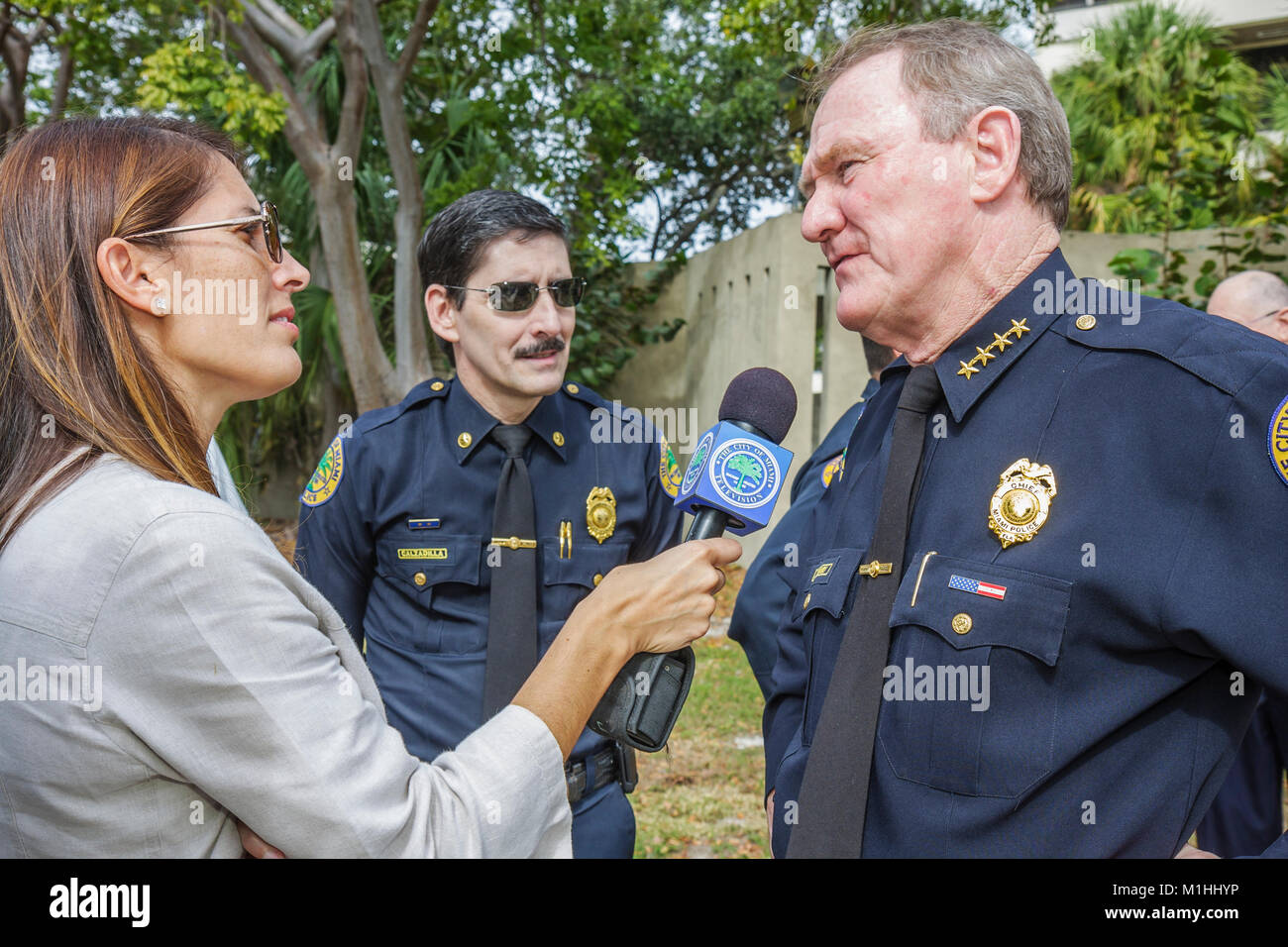 media Hispanic reporter woman interview microphone Police Chief John ...