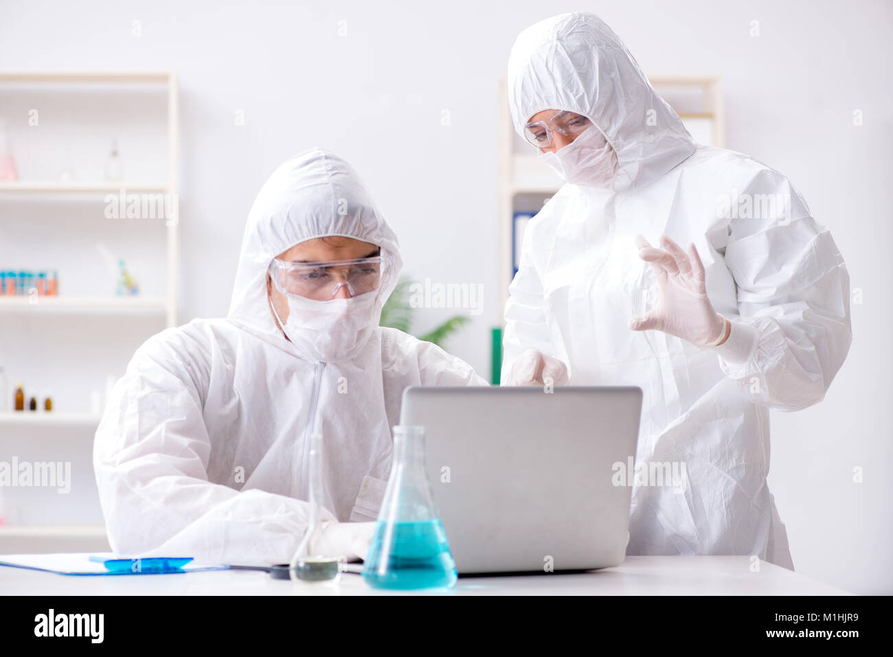 Two chemists working in the lab Stock Photo - Alamy