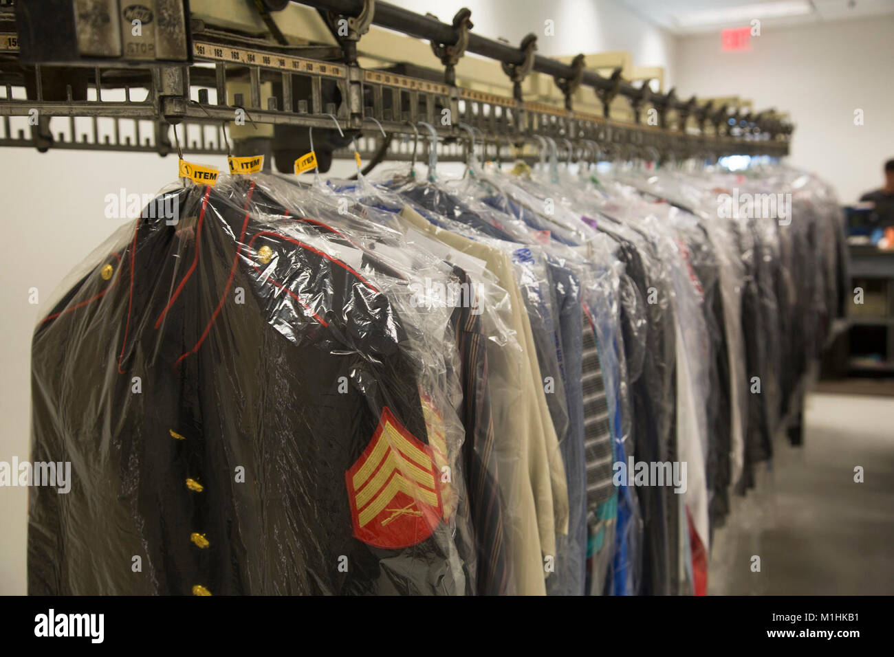 U.S. Marine Corps uniforms hang on turnstiles at the dry-cleaners on ...