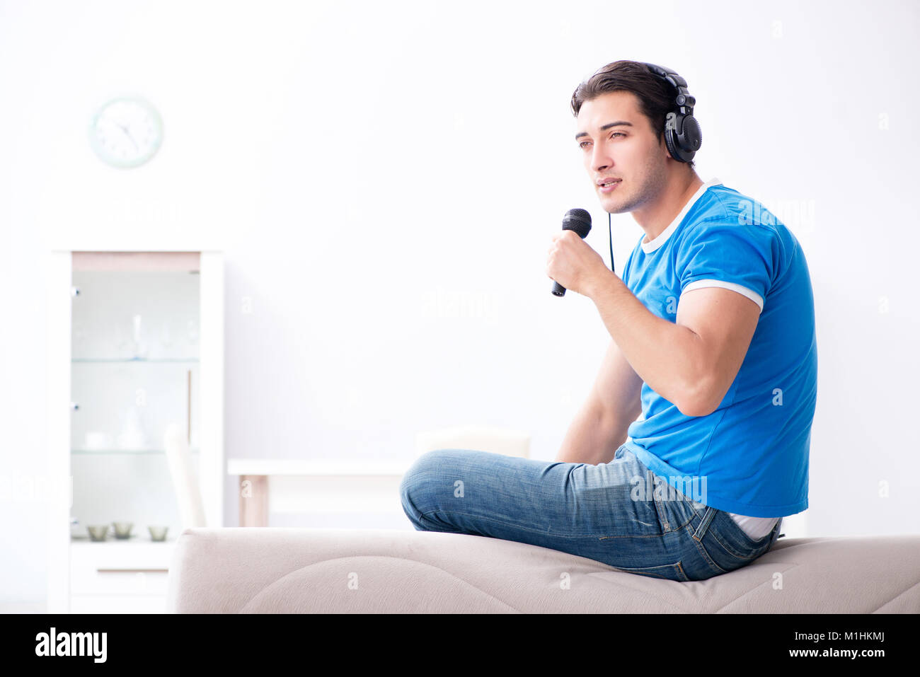 Young man singing at home karaoke Stock Photo - Alamy