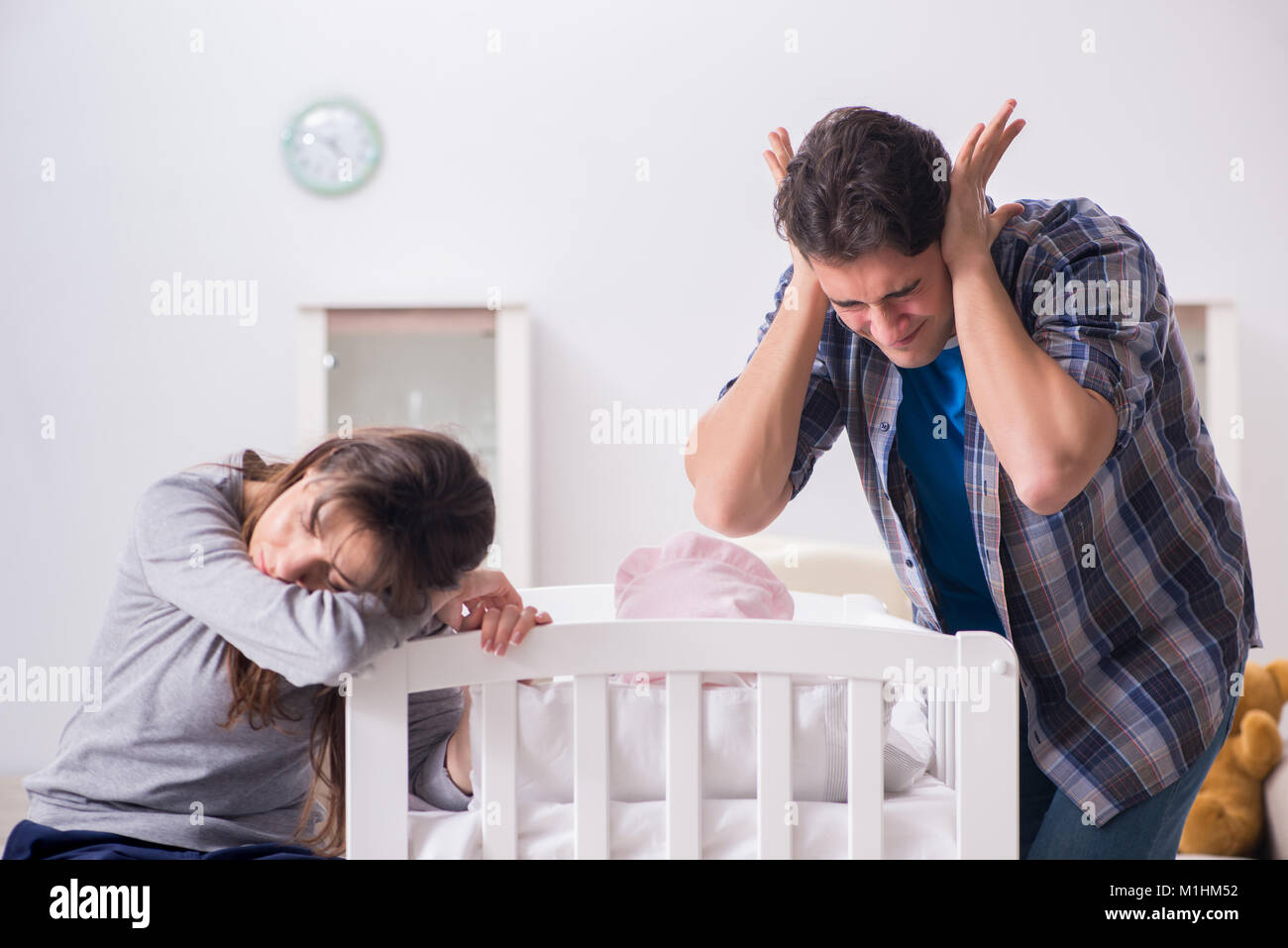 Young dad cannot stand baby crying Stock Photo - Alamy