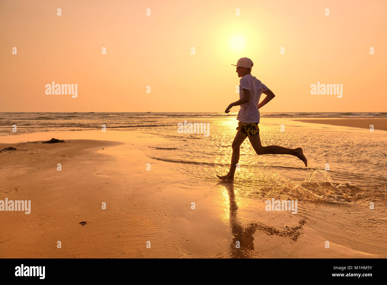 Male jogger on beach hi-res stock photography and images - Alamy