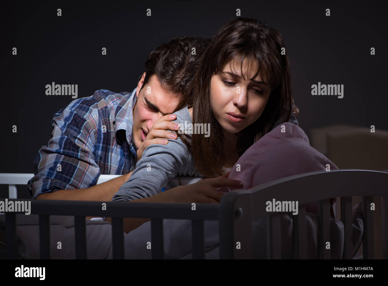 Young parents sleepless with newborn baby at night Stock Photo - Alamy