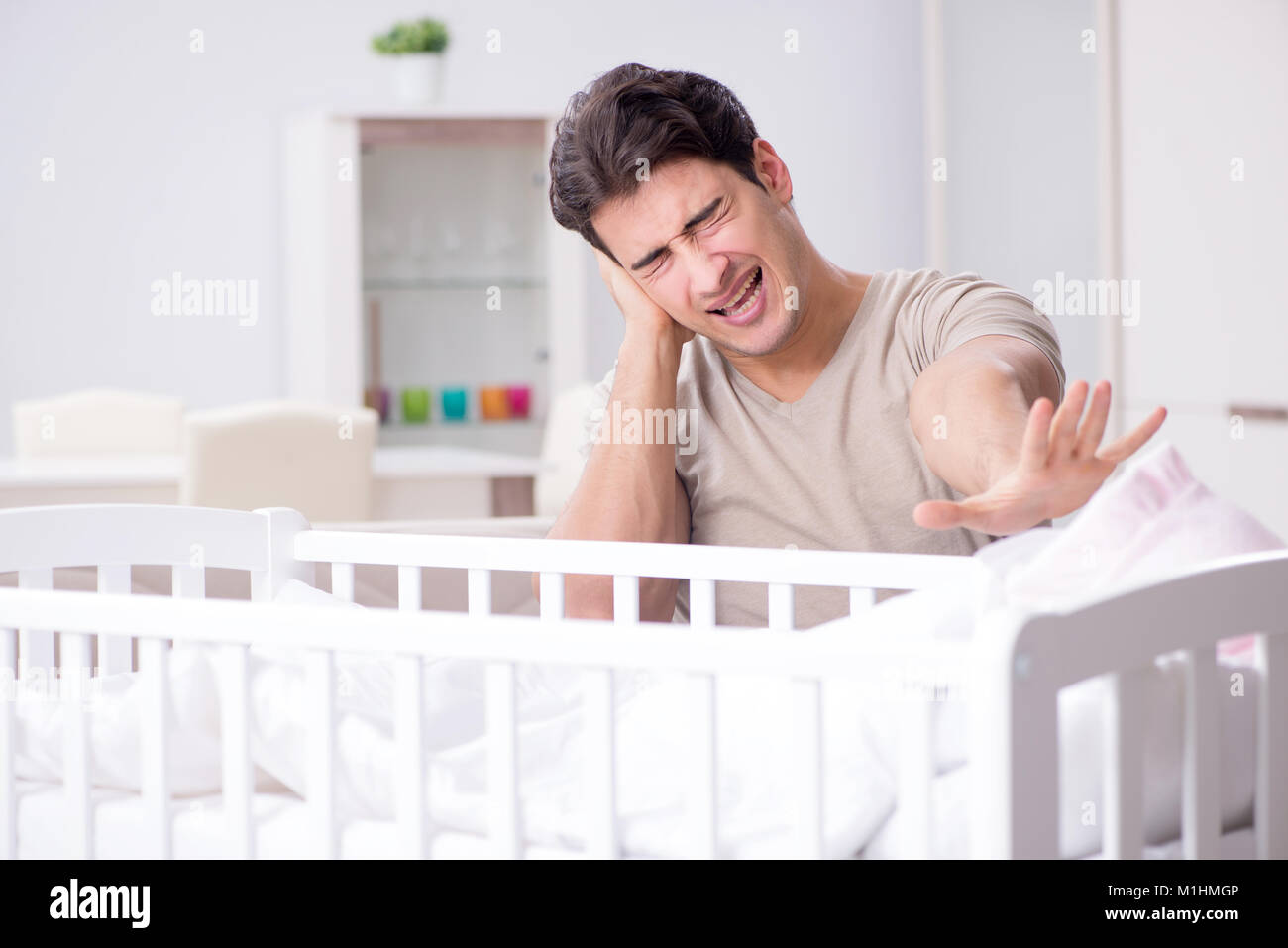 Young father dad frustrated at crying baby Stock Photo - Alamy