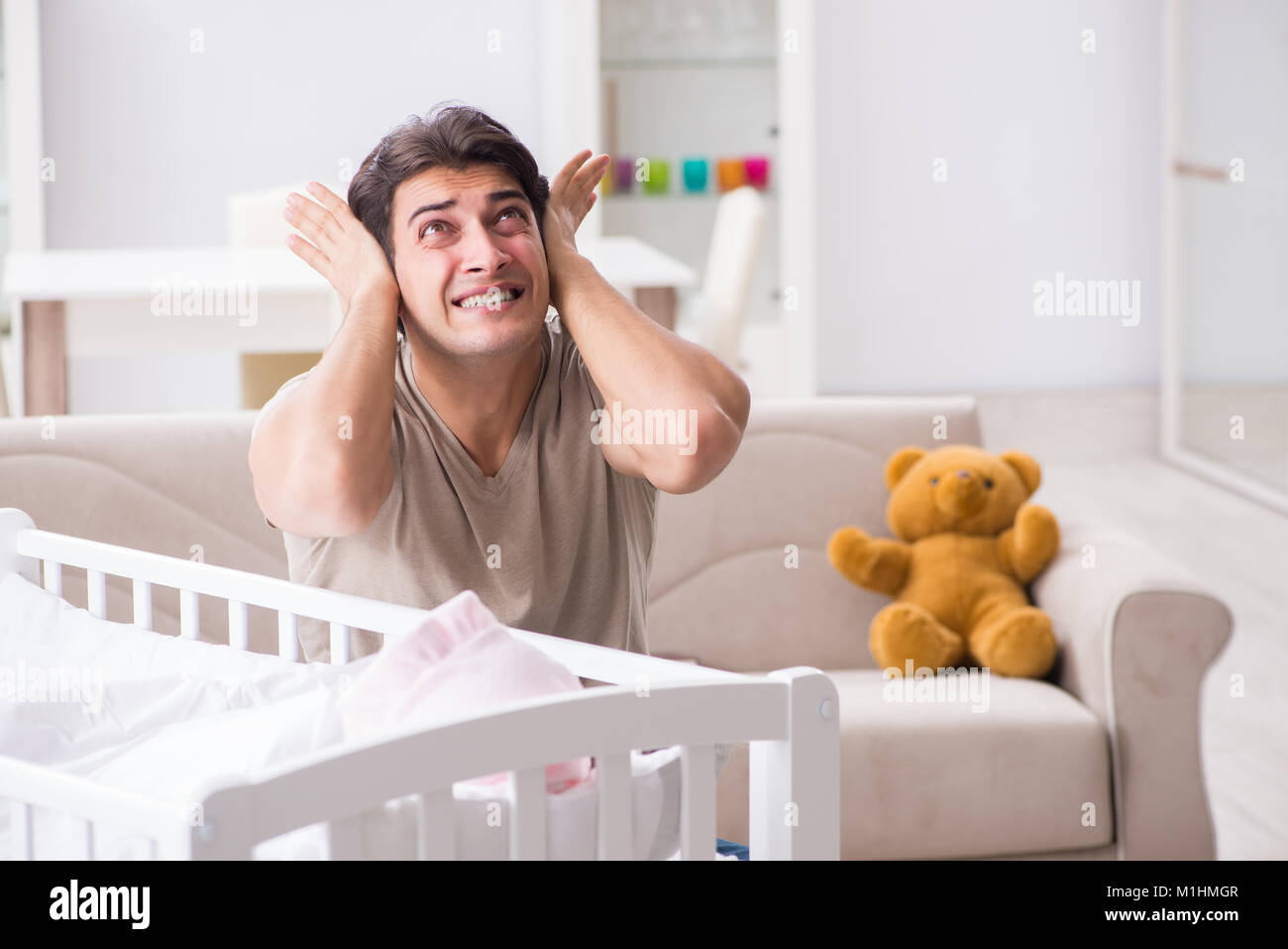 Young father dad frustrated at crying baby Stock Photo - Alamy