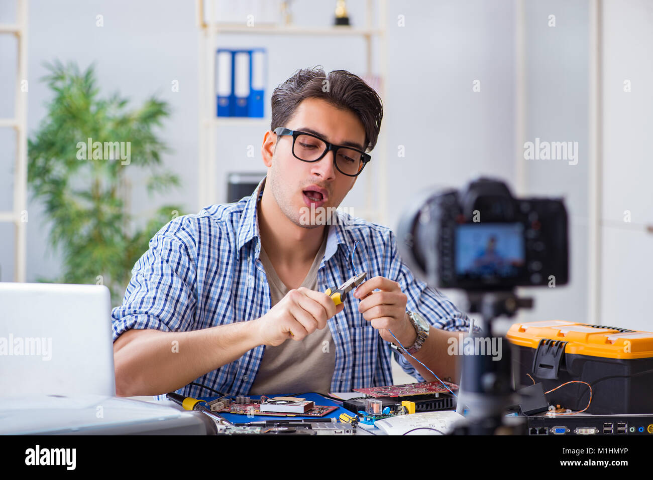 Vlogger recording computer repair on camera for vlog blog Stock Photo ...