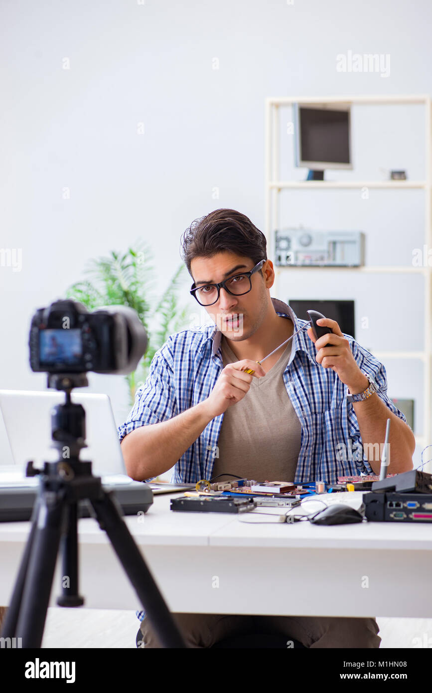 Vlogger recording computer repair on camera for vlog blog Stock Photo ...
