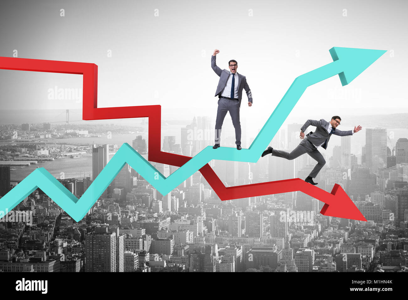 Businessman with charts of growth and decline Stock Photo - Alamy