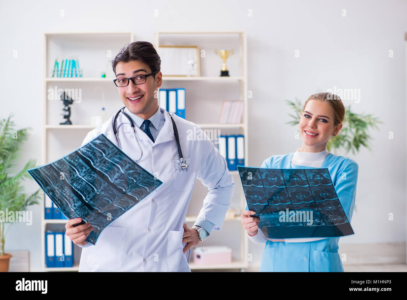 Two doctors examining x-ray images of patient for diagnosis Stock Photo ...