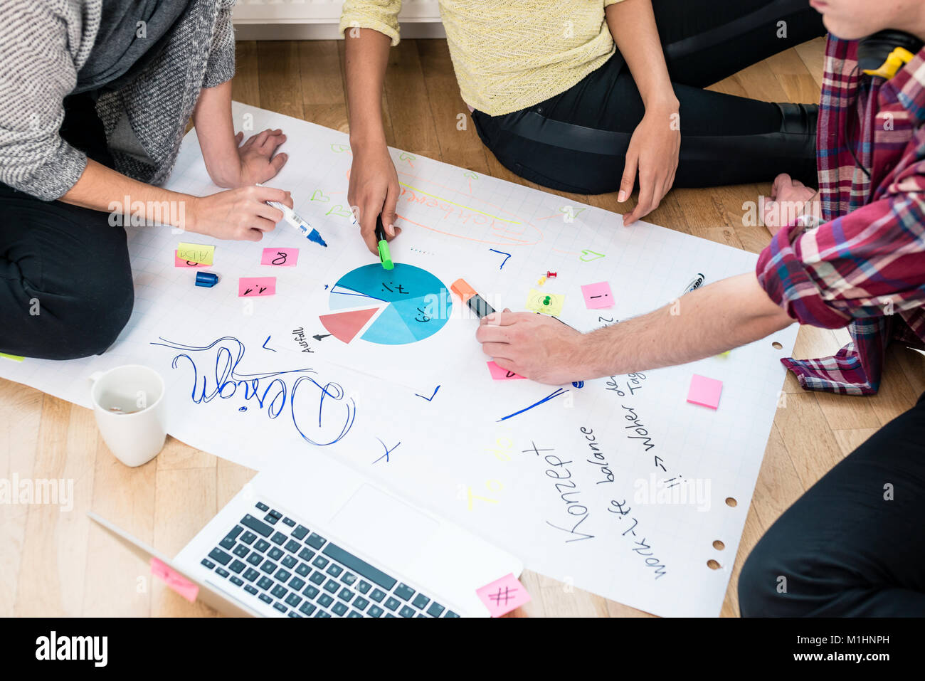 Three people writing observations during brainstorming session Stock ...