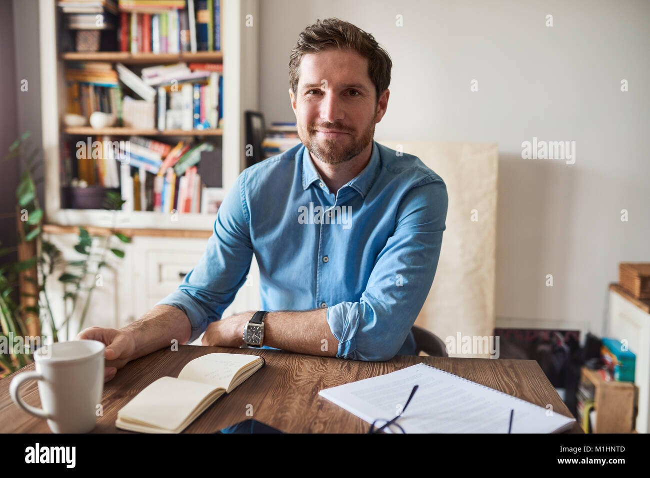 Happy man working table hi-res stock photography and images - Alamy