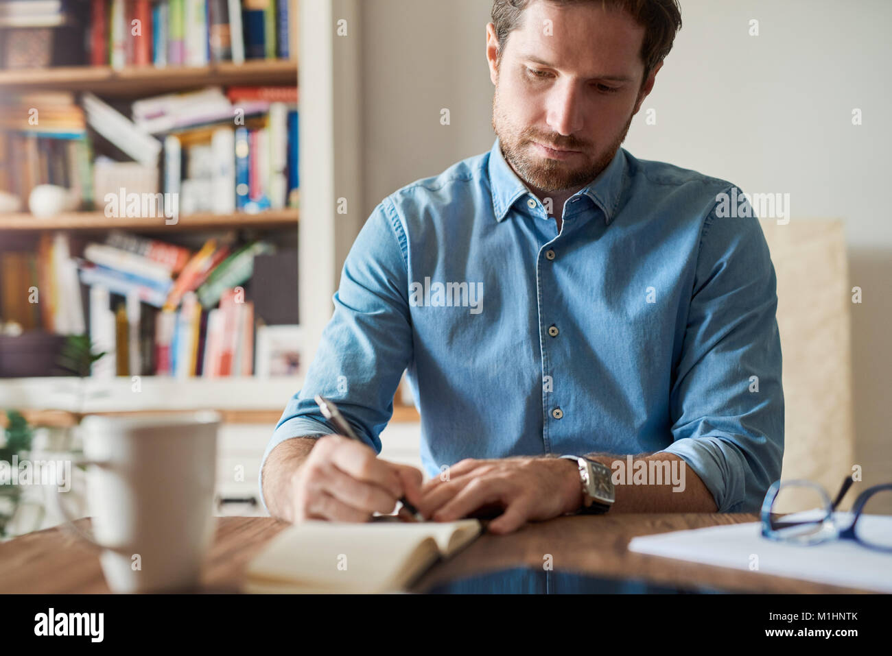 Man writing down hi-res stock photography and images - Alamy