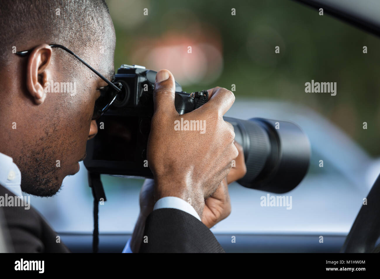 Side View Of A Private Detective Sitting Inside Car Photographing With ...