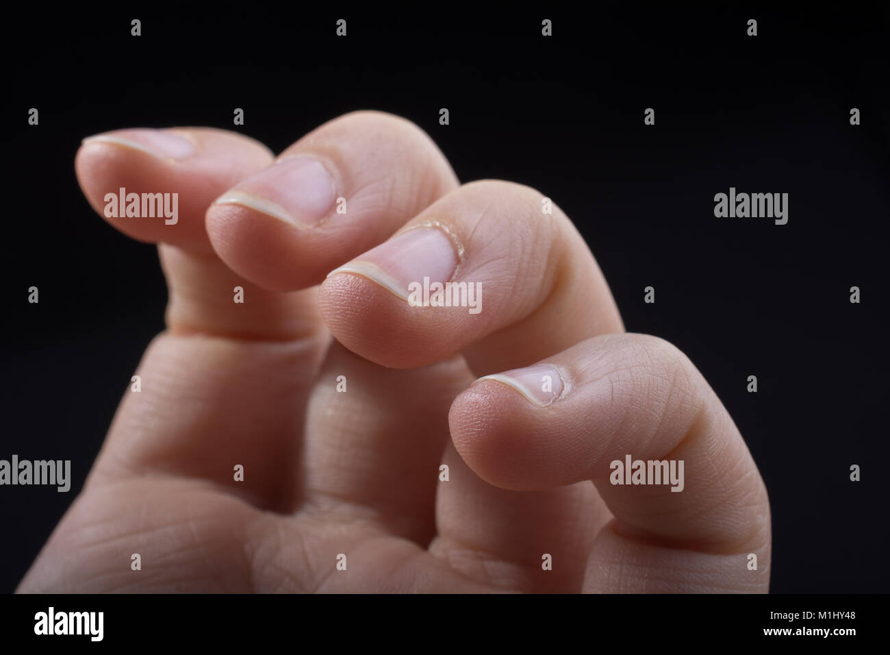 Four fingers of a child hand partly seen in black background Stock ...