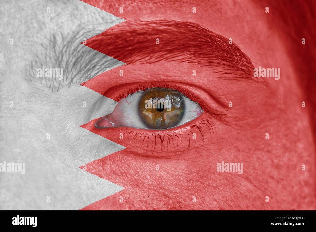 Human face and eye painted with flag of Bahrain Stock Photo - Alamy